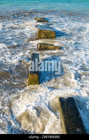 Waves crash on breakwaters. Splashes of water, drops, splash. Marine ...