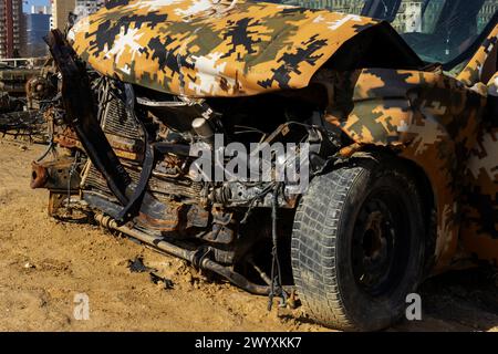 A damaged military armored vehicle, a passenger car , a jeep and ...