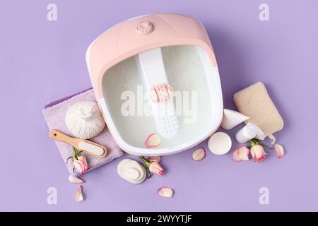 Set for foot massage on purple background Stock Photo - Alamy
