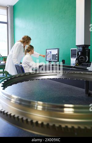 Technicians inspecting aircraft component. Measurement of a piece in ...