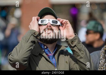 Boston, USA. 8th Apr, 2024. People watch a solar eclipse in Boston, the ...