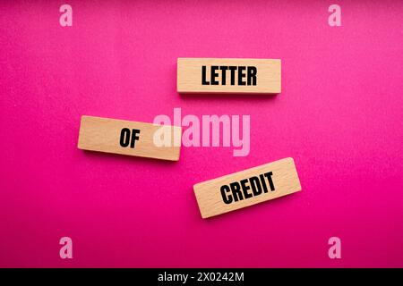 Letter of credit words written on wooden blocks with pink background ...