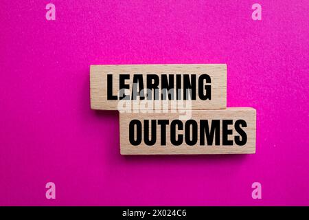 Learning outcomes words written on ripped paper piece with brown ...