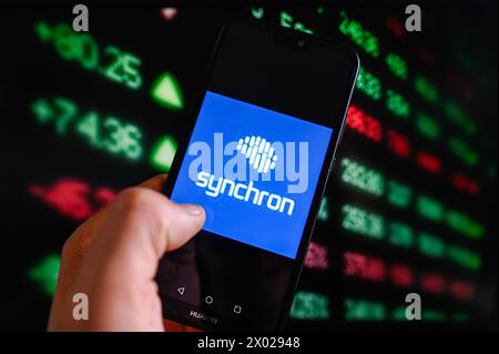 In this photo illustration, a Synchron logo is displayed on a ...