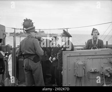 Rear Admiral Sir Harold Burrough and naval and army officers oversee ...