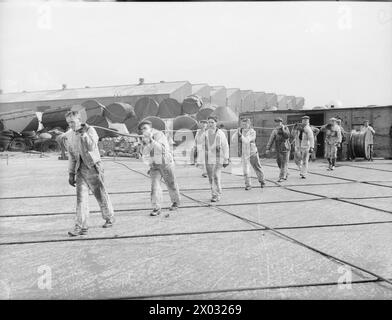 In September 1940, workmen at a boom defence depot handled and ...
