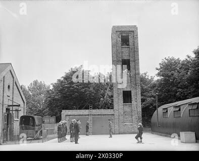 ROYAL NAVAL FIRE FIGHTERS GO THROUGH THEIR PACES. 25 JUNE 1943, CHATHAM ...
