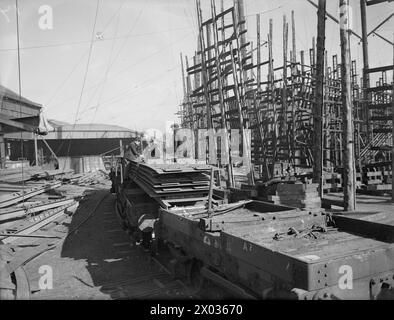 Pre-fabricated ship sections are unloaded from trucks at Furness and Co ...