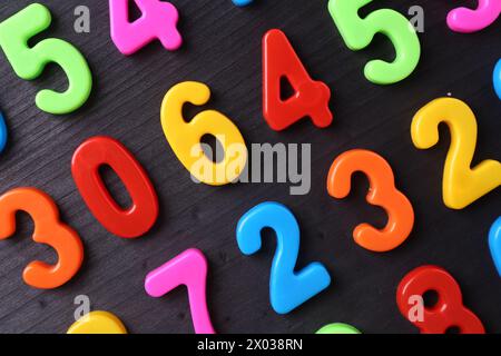 Colorful numbers on dark wooden school desk, flat lay Stock Photo - Alamy