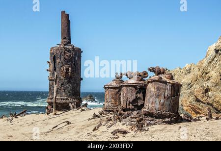 Rusted remains of the desalination plant by the Bogenfels Rock Arch in ...