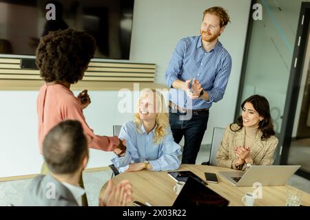 Multiethnic group of professionals brainstorming around a conference ...