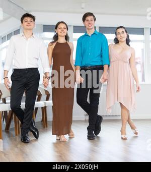 Girls and guy dancing folk dance in row in dance studio Stock Photo - Alamy