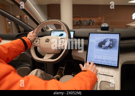 steering wheel NIO EL7, close-up male driver's hand manipulates on ...