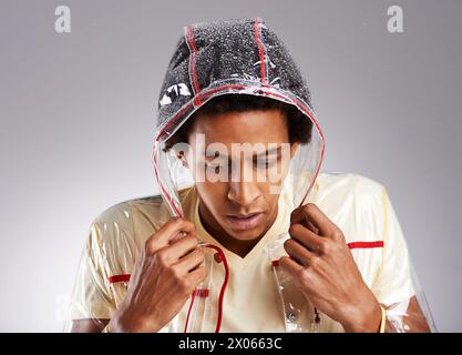 Cold, black man and studio with raincoat for fashion in winter with ...