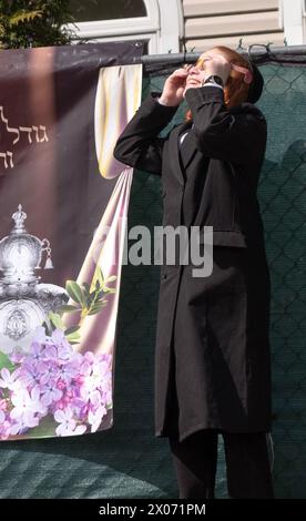 An Ultra-Orthodox Jewish yeshiva student walks past candles marking the ...