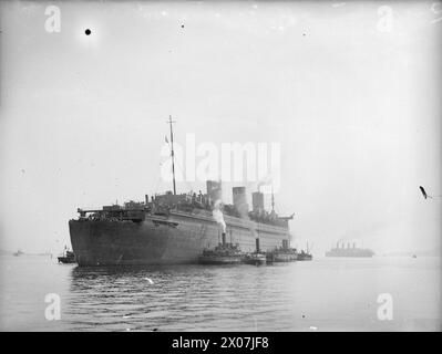 FORMER LUXURY LINER, NOW TROOPSHIP, SS QUEEN MARY AT A BRITISH PORT. 21 ...