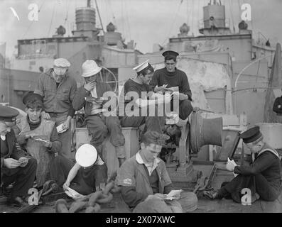 Royal Navy sailors reading letters from home, early 1900s Stock Photo ...