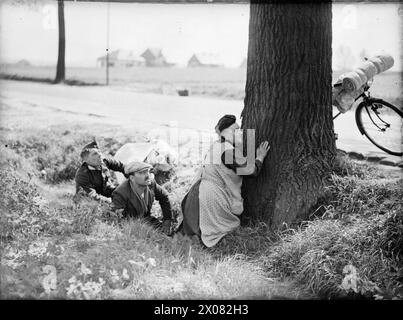 Refugees in Belgium, May 1940 Refugees take cover in a roadside ditch ...