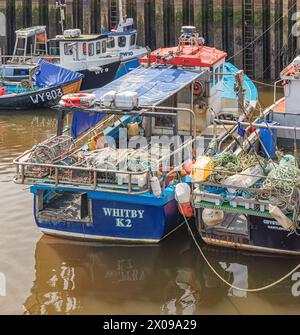 A fishing boat's name is reflected in the waters of Cockrell Creek in ...