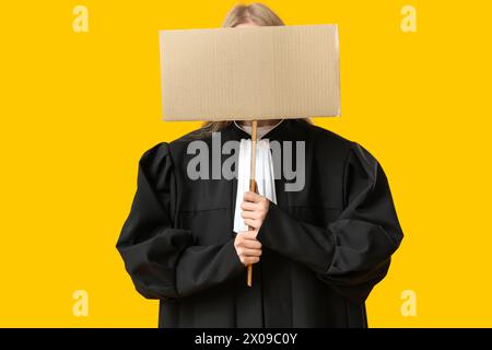 Protesting female judge holding placard with text ON STRIKE and ...