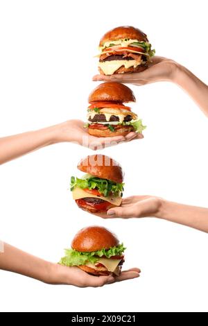 Female hands holding tasty burgers on white background Stock Photo - Alamy