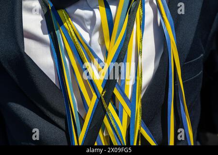 Blue and yellow bands hanging around the neck of a student Stock Photo ...