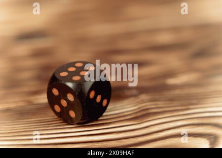 A detailed view of a single dice with clear markings, sitting on a ...