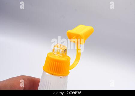 Human hand applying white glue orange paper with scissor stapler Stock ...