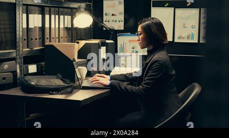 Detective uses forensic techniques to examine evidence stored in the ...
