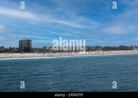 Venice Beach filled with sunbathers, sufers and people swimming as seen ...