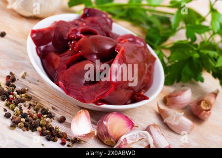 Image of raw rabbit liver with garlic and greens Stock Photo - Alamy