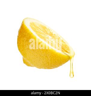 Fresh lemon juice dripping isolated on white background. Clipping path ...