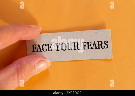 Face your fears words written on paper pieces with green background ...