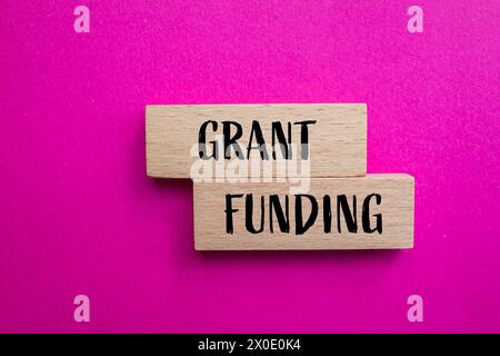 Wooden blocks with symbol of crowdfunding concept on blue background ...