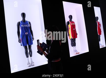 Paris, France. 11th Apr, 2024. A visitor takes photos of Nike Olympics ...