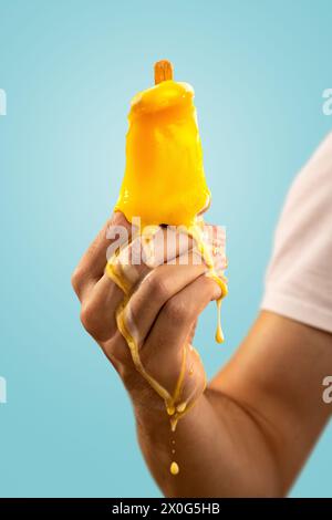 Melting Ice Pop Held by a Hand with Copy Space Stock Photo - Alamy