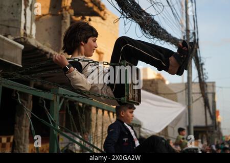 Mosul, Iraq. 11th Apr, 2024. Iraqi children play on a hand-powered ...