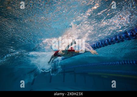 Boundless energy and motivation. Athletic young man, swimmer in cap and ...