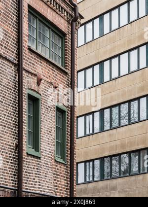 A sleek modern structure stands tall, framed by lush greenery and ...