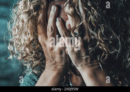 Face in the hands of a desperate and crying teenage girl, close up ...