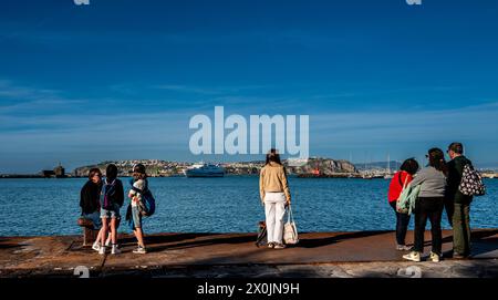 People watching the Caremar ferry Isola di Vulcano arriving in Procida ...
