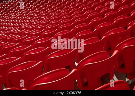 Symmetry pattern of red seats in a football stadium Stock Photo - Alamy