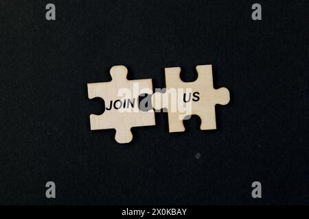 Interlocking jigsaw puzzle pieces forming the phrase JOIN NOW ...