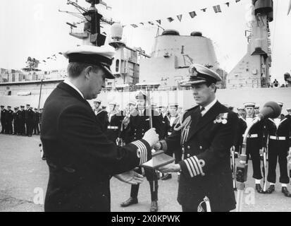 THE CAPTAIN OF THE NEW HMS COVENTRY CAPT. TED HACKETT, LEFT, RECEIVES ...
