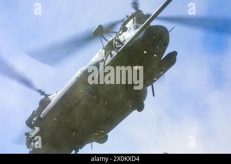 A MH-47 Chinook helicopter hovers to prepare for U.S. Army Rangers to ...