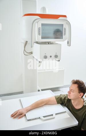 Adult man undergoing upper extremity x-ray examination Stock Photo - Alamy