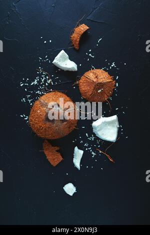 Raw broken coconut on dark background. Tropical food concept. Copy ...