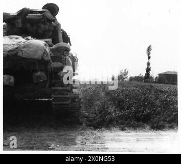 EIGHTH ARMY ADVANCE - A Sherman tank moving in pursuit of the ...
