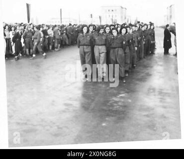 Photograph of 1st Corps partisan troops marching past a saluting base ...