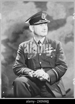 Air Vice Marshal J. Whitworth-Jones, C.B., is shown at his desk in an ...